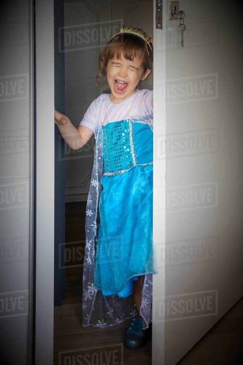 Portrait of a girl dressed as a princess opening a door - Royalty-free ...