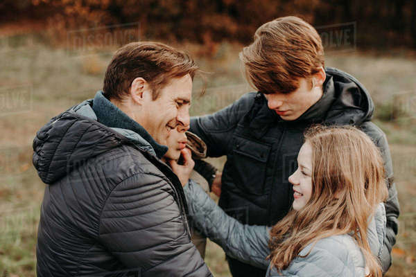 Father and three children standing in rural landscape, Netherlands ...
