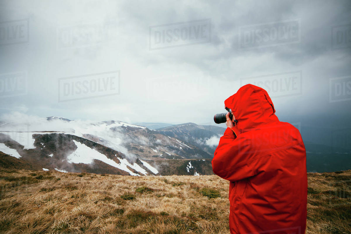 Man photographing landscape - Stock Photo - Dissolve