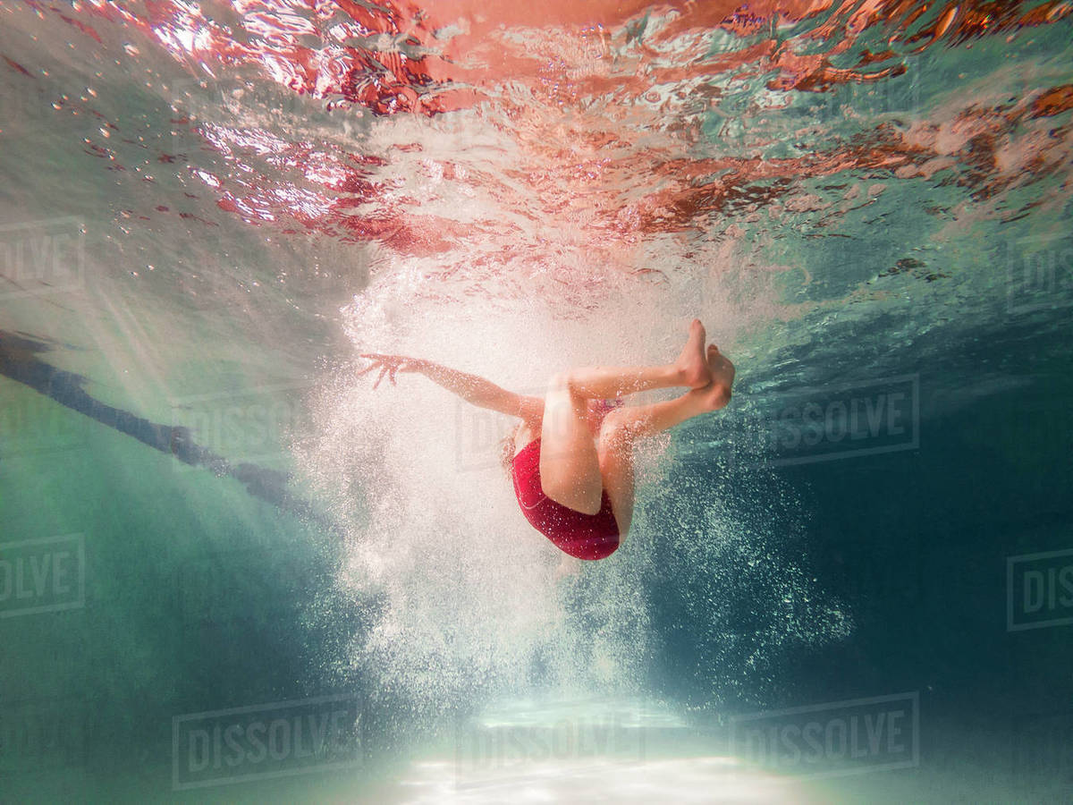 Girl jumping into a swimming pool - Royalty-free Stock Photo | Dissolve