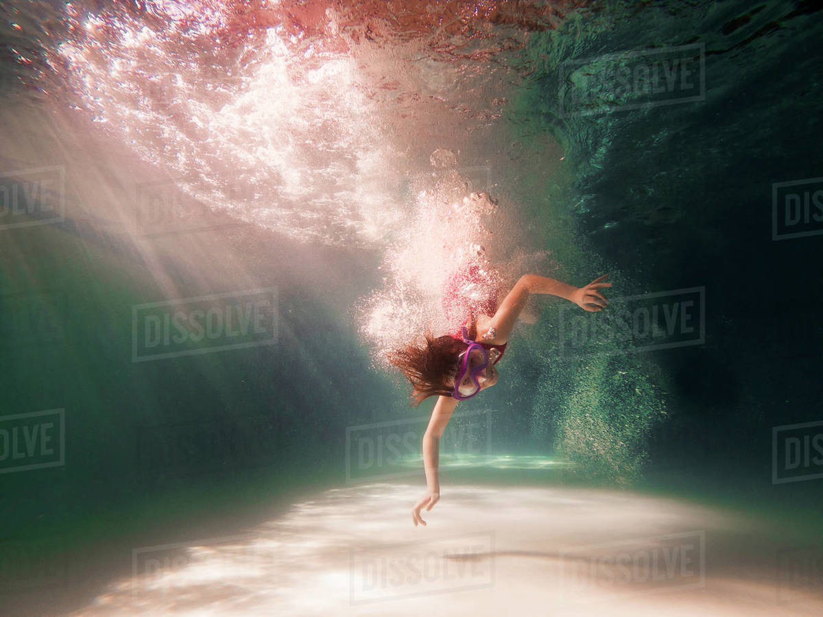 Girl diving into a swimming pool - Royalty-free Stock Photo | Dissolve