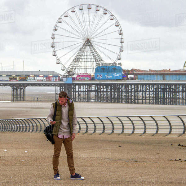 Man on a smartphone in blackpool - Royalty-free Stock Photo | Dissolve