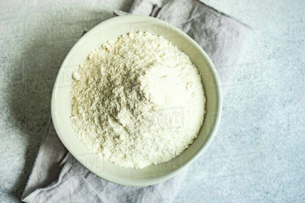 Overhead view of a bowl of flour on a folded napkin - Stock Photo ...