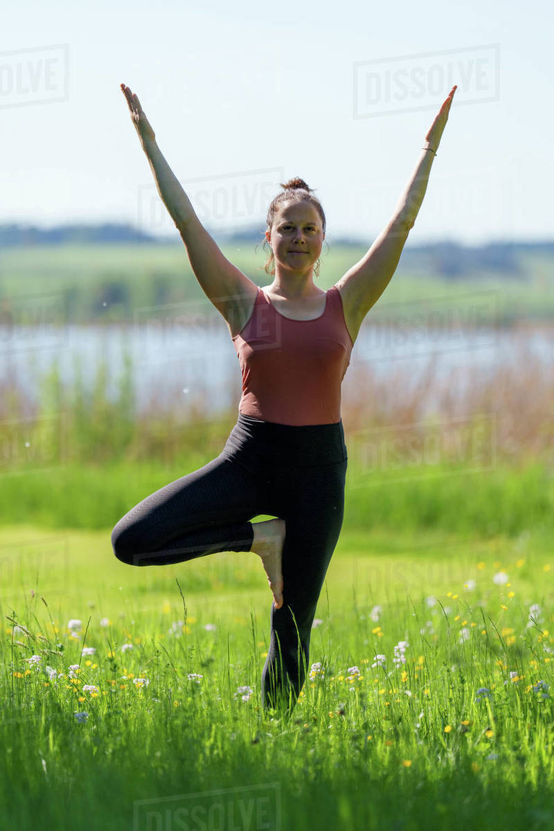 Woman doing tree pose by Wallersee, Salzburg, Austria - Royalty-free ...
