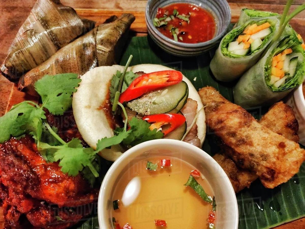 Overhead view of spring rolls, Summer rolls, rice parcels, pork bao ...