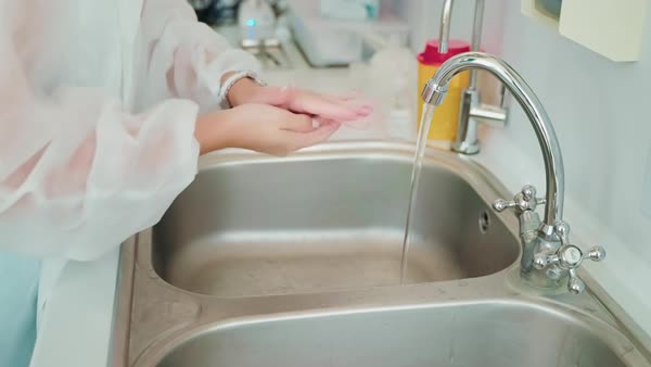 Doctor or nurse washing hands before or after patients appointment in ...