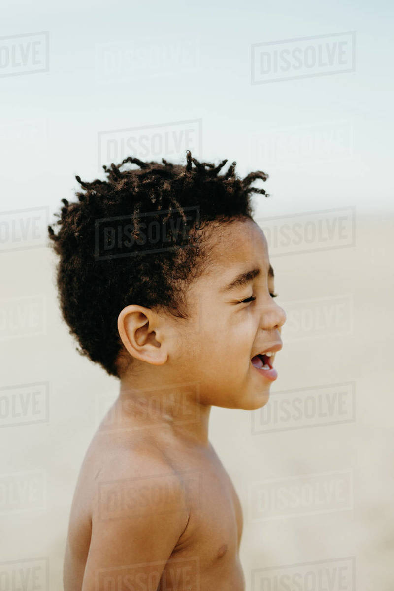 Side view of adorable shirtless African American boy with closed eyes ...