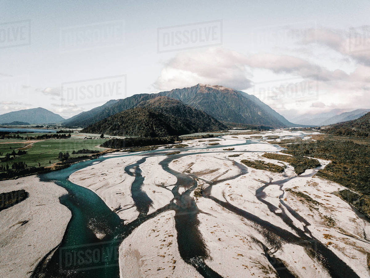 Picturesque landscape of Taramakau River with shallow water flowing ...