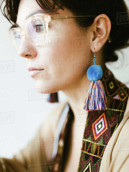 Side view of attractive dreamy young brunette with bright handmade ...