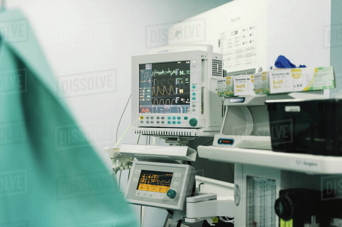 Medical equipment with screens showing vital signs of patient in ...