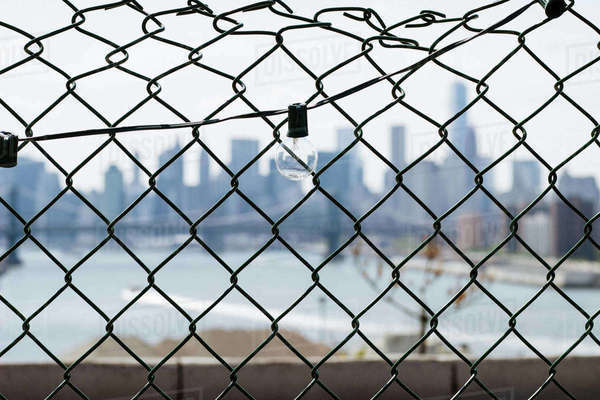 Urban landscape of architecture of New York City through chain link ...