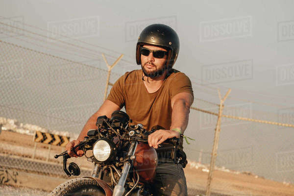 Strong man driving motorcycle - Royalty-free Stock Photo | Dissolve