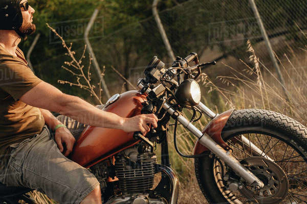 Strong man driving motorcycle - Royalty-free Stock Photo | Dissolve