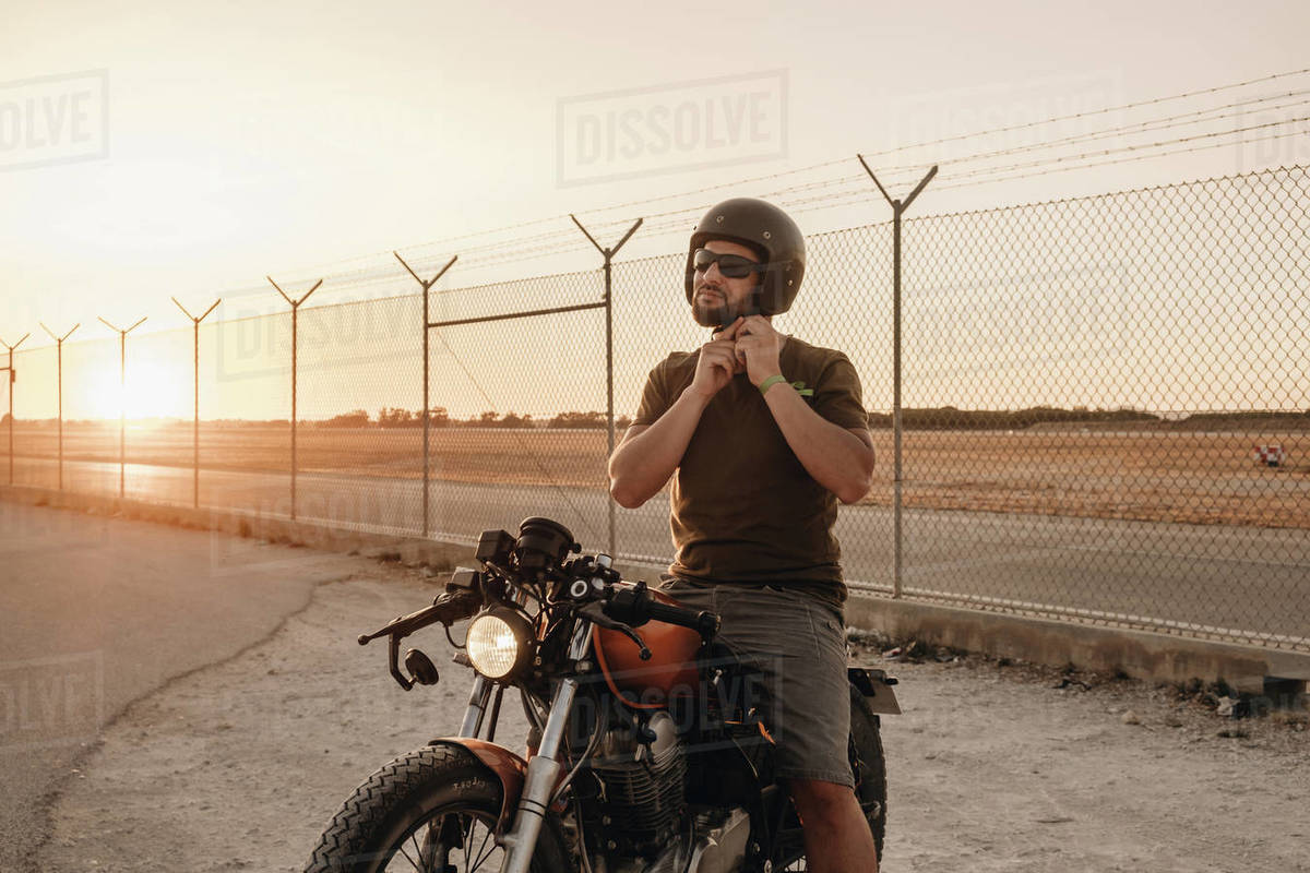 Strong man driving motorcycle - Stock Photo - Dissolve