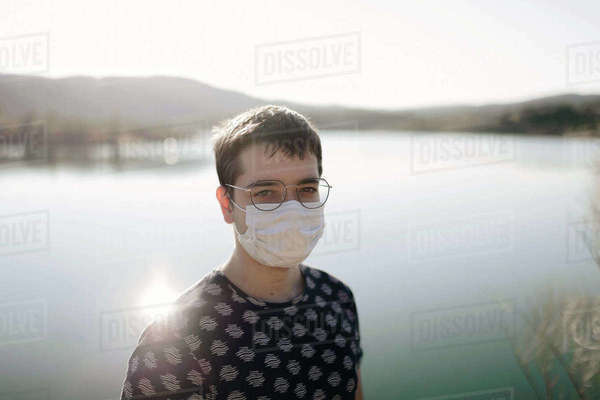 Unrecognizable young tourist in face mask and eyeglasses standing near ...