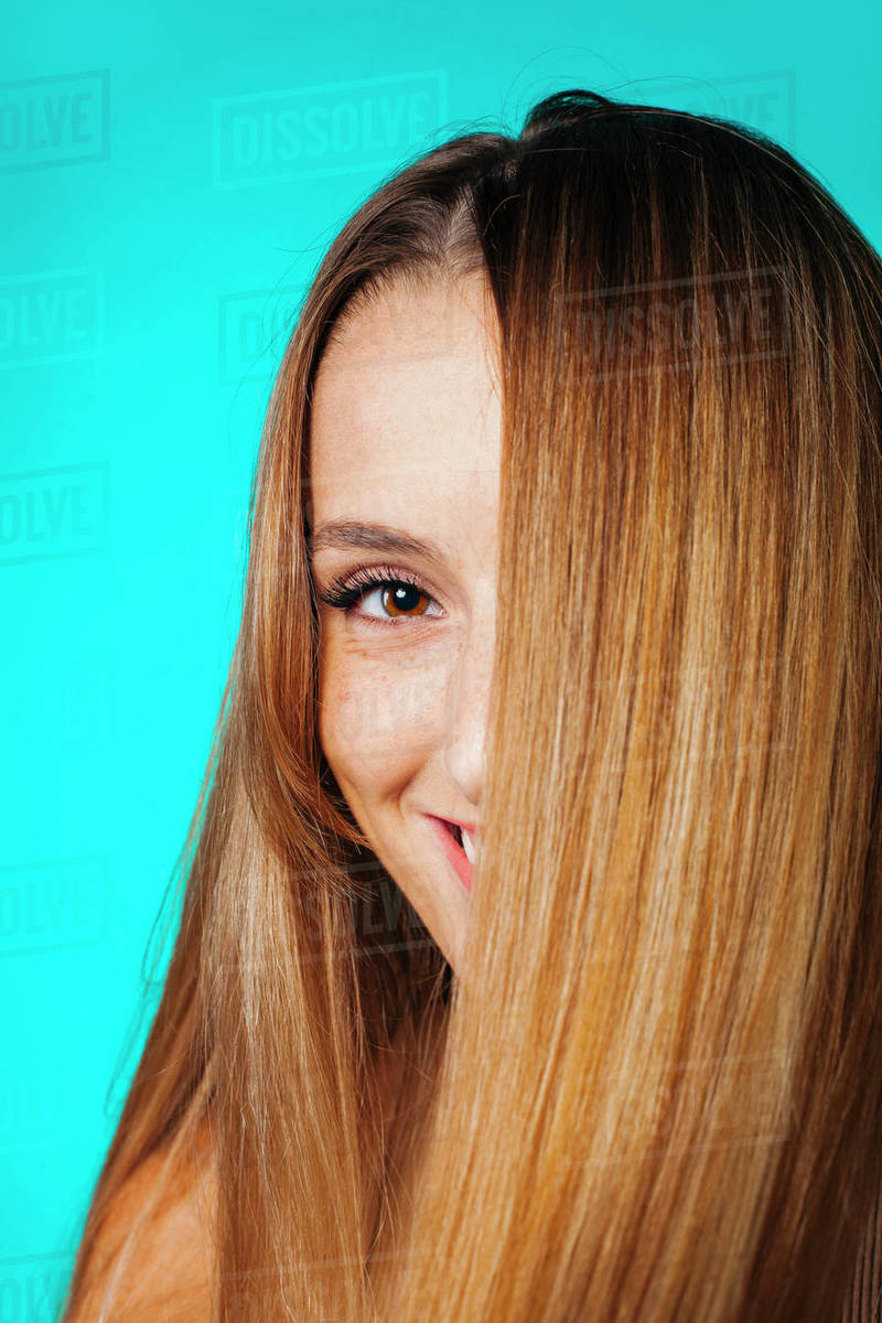 Charming positive young female with long straight fair hair covering ...