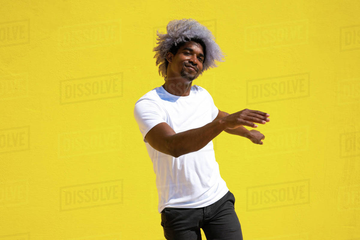 Afro black man dancer dancing on a yellow background. Dance and music ...