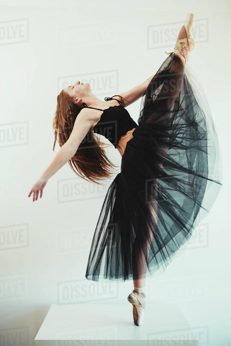 Side view of graceful female ballet dancer in pointe shoes and black ...