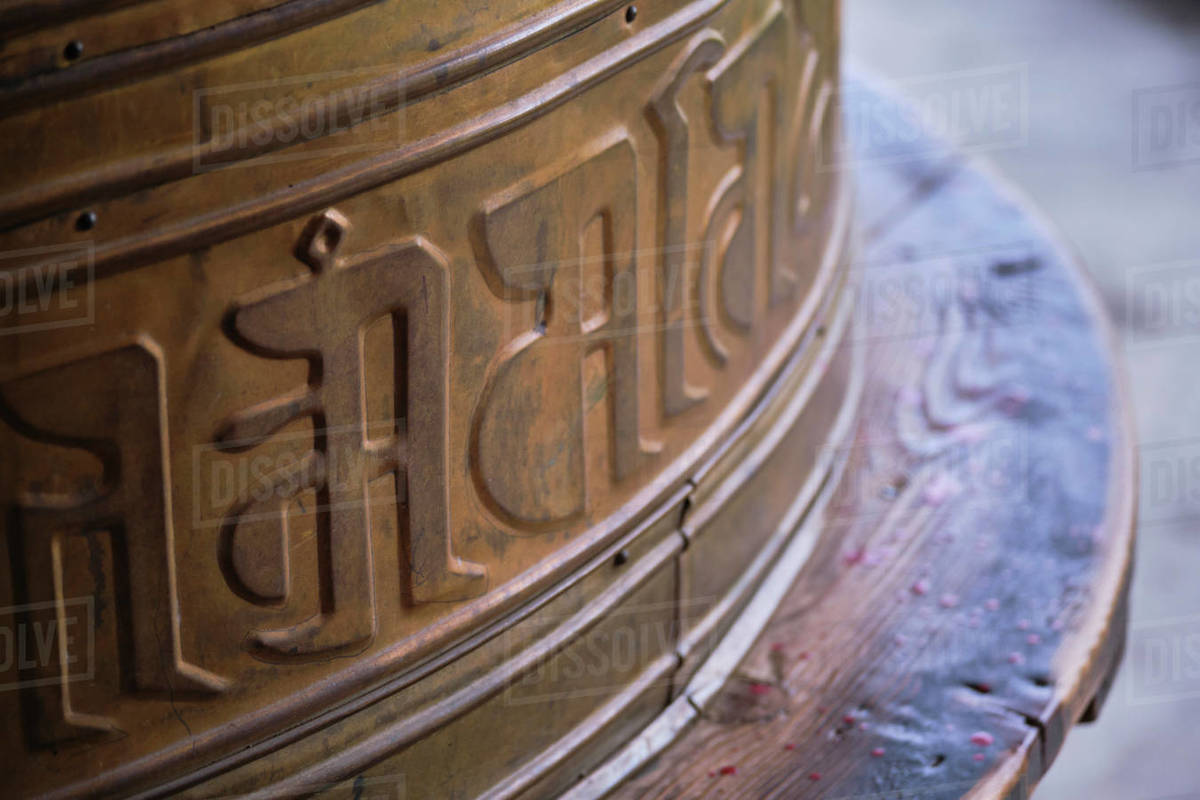 Old stone Tibetan rolls with sacred mantra consisting of sanskrit ...