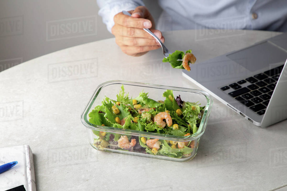Crop view of unrecognizable office employee sitting at table in ...