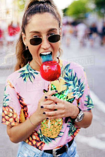 Cheerful lady having fun enjoying sweet candy apple - Royalty-free ...