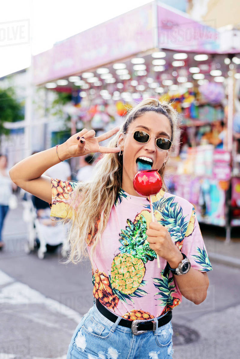 Cheerful lady having fun enjoying sweet candy apple - Royalty-free ...