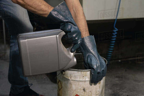 Faceless male employee working at workshop - Stock Photo - Dissolve
