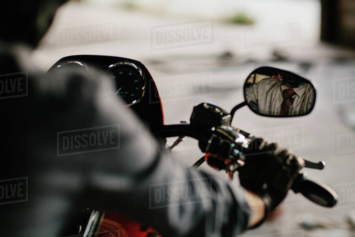 Elegant man sitting on his pretty motorcycle inside a garage - Stock ...