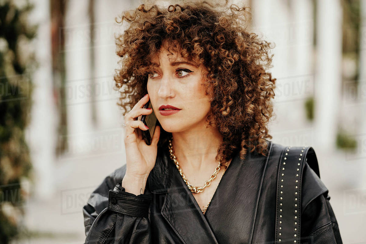 Full body female entrepreneur in vintage outfit walking on asphalt path ...