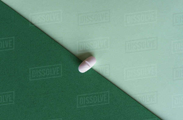 Top view of prescription pill for flu treatment placed on green and ...