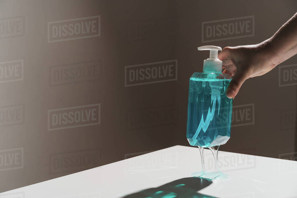 Plastic transparent bottle with blue liquid soap located on white ...