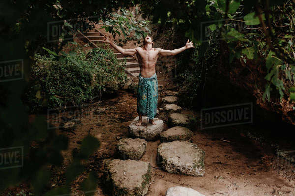 Full body unrecognizable muscular shirtless male in traditional ...