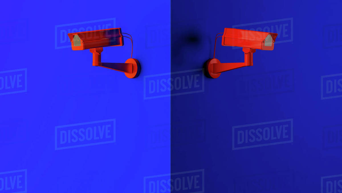 Red surveillance camera on blue background monitoring people on the ...