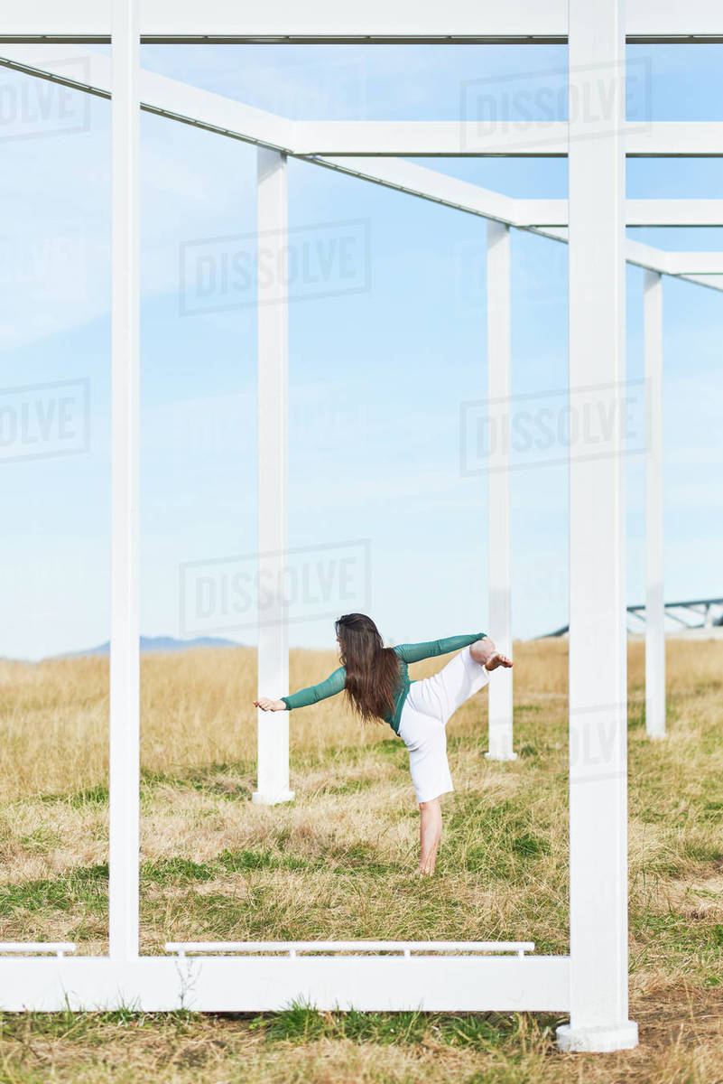 Back view of unrecognizable female bending back and falling down while ...