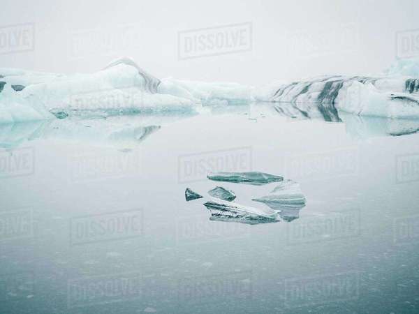 Picturesque view of ice on water surface between snow in winter in ...