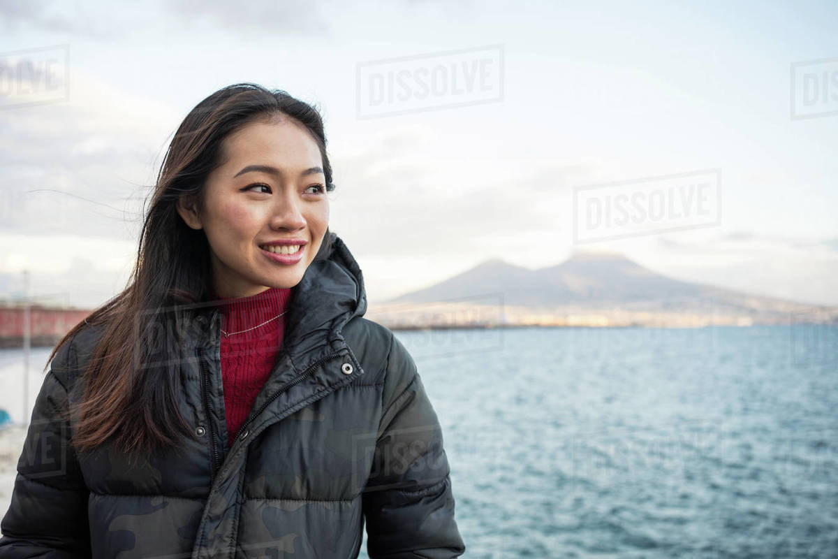 Satisfied resting female in warm clothing enjoying view of beautiful on ...