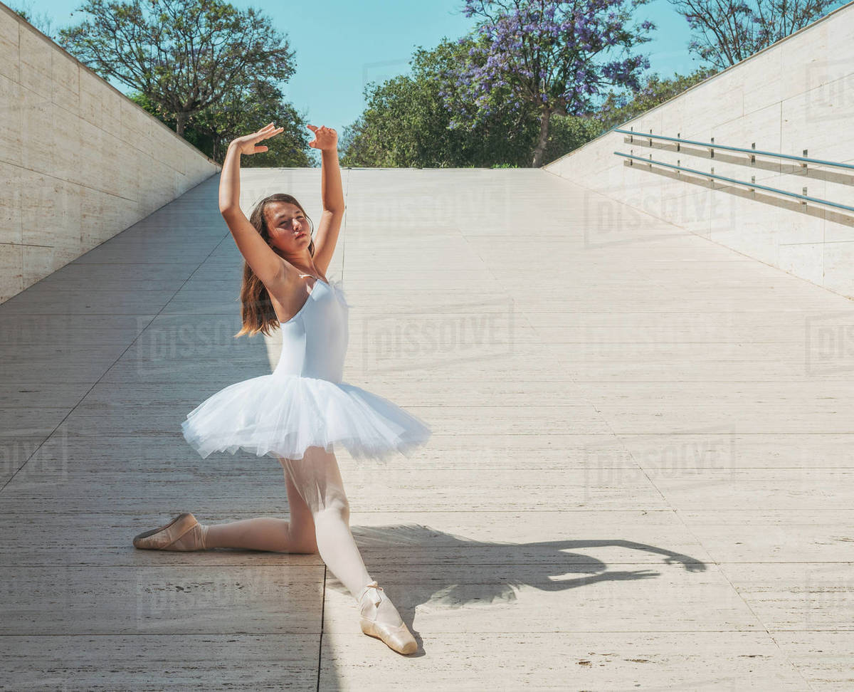 Classical ballet position gracefully performing by ballerina with ...