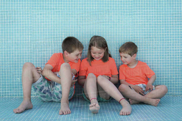 Children sitting in empty pool and reading book - Royalty-free Stock ...