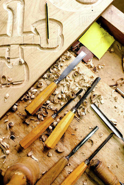 Top view of set of various chisels for wood carving placed on messy ...