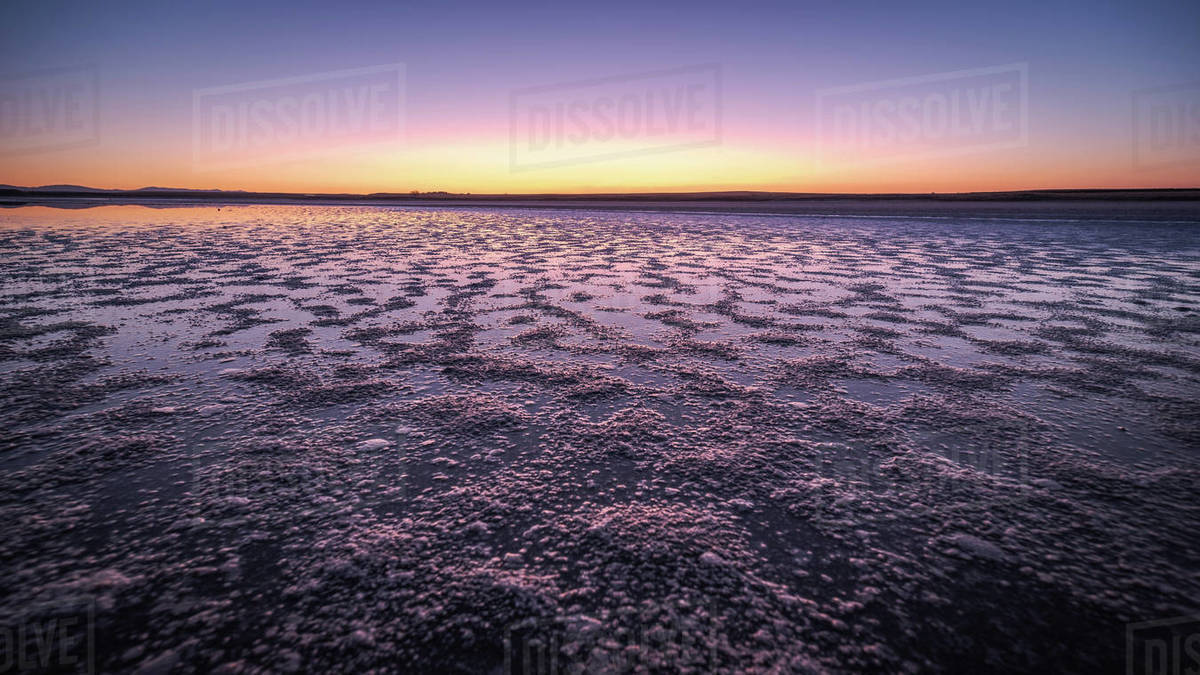Beautiful colorful sunset sky over dried river with drought and damp ...