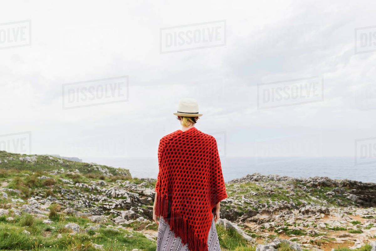 Back view of unrecognizable female traveler in stylish outfit and hat ...
