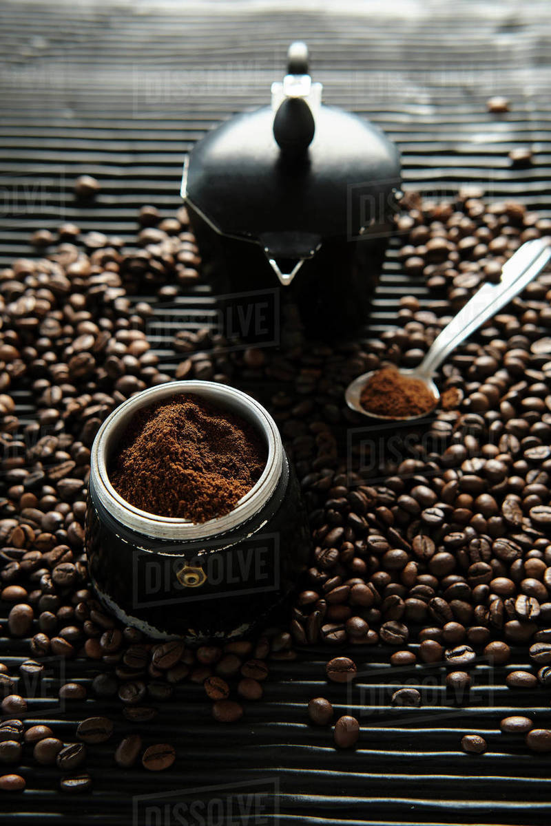 From above of ground coffee in traditional coffee maker placed on table ...