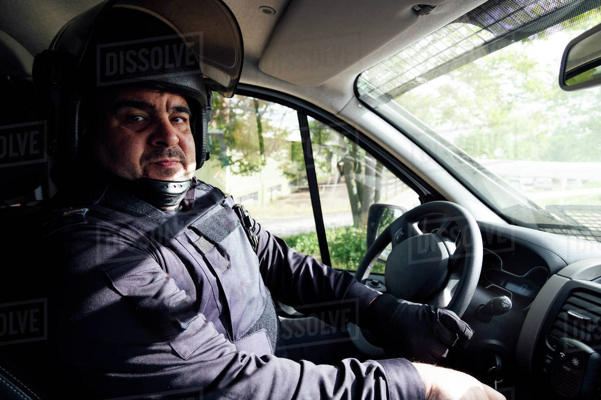 Side view of serious plump middle aged police officer in uniform and ...