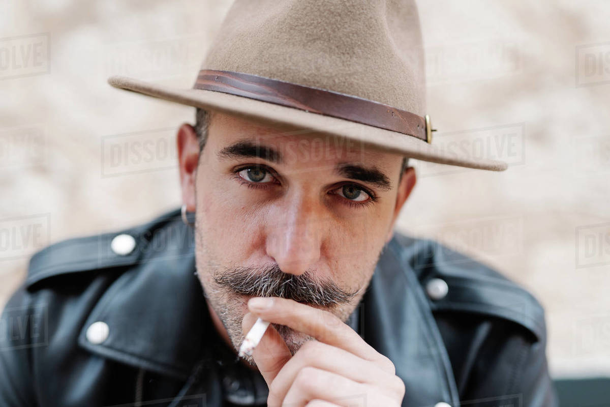 Cool handsome guy in with gorgeous mustache smoking cigarettes and ...