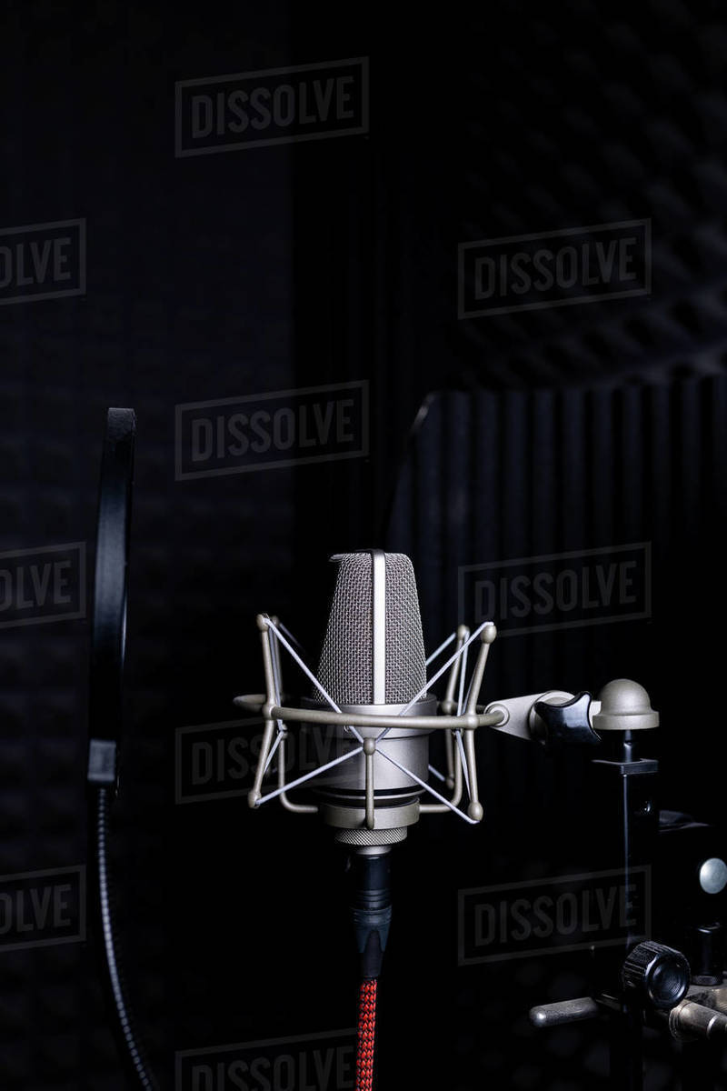 Contemporary metal microphone with wire placed on background of ...