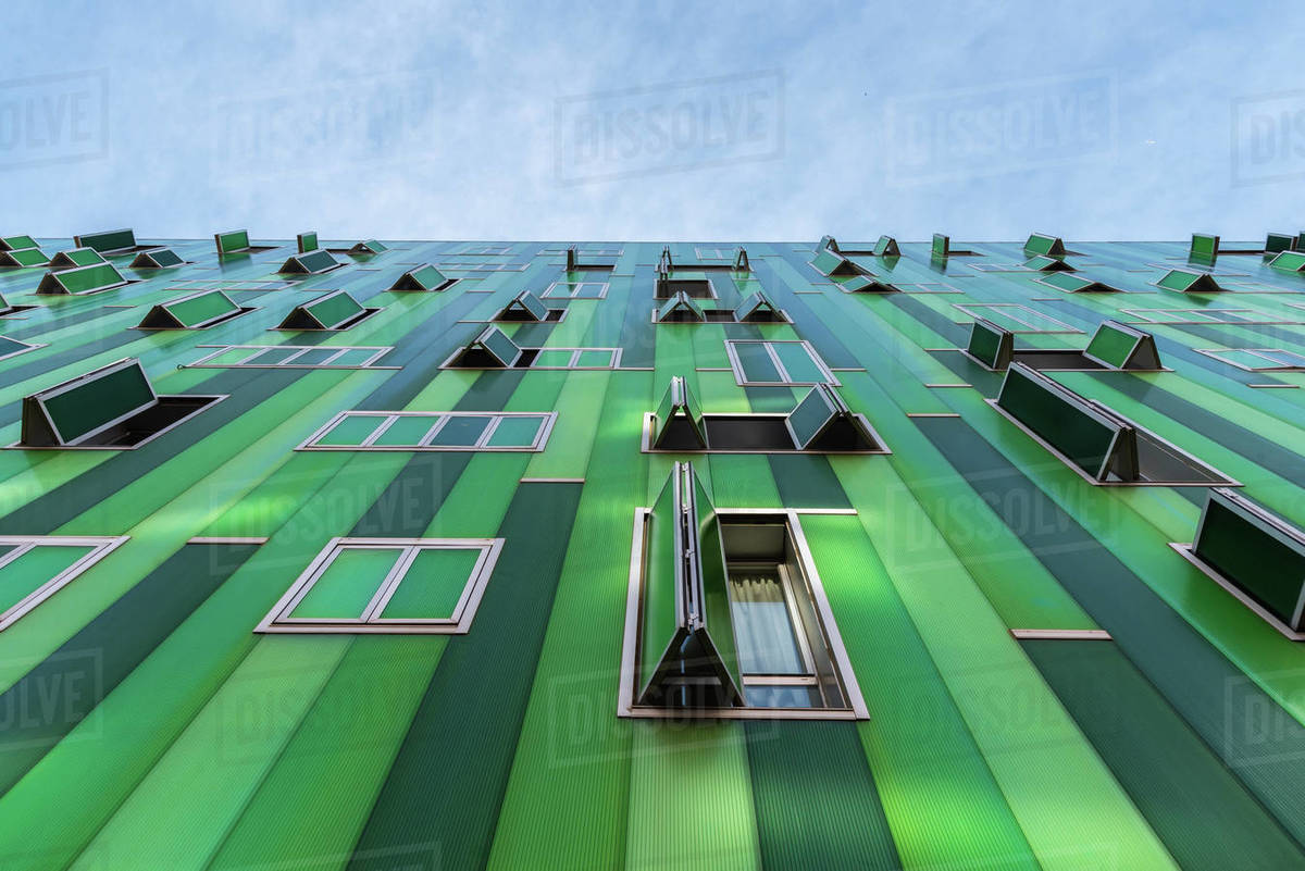 From below contemporary building with vivid green facade and opened ...