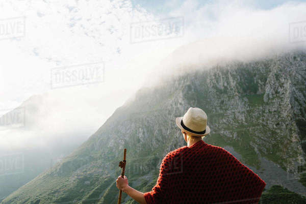 Back view of unrecognizable wanderer with wooden staff enjoying ...