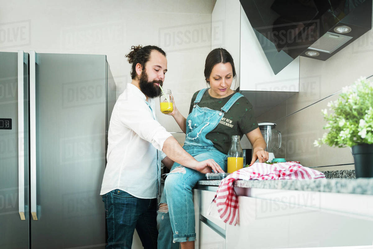 Couple drinking orange juice and eating healthy food while spending ...
