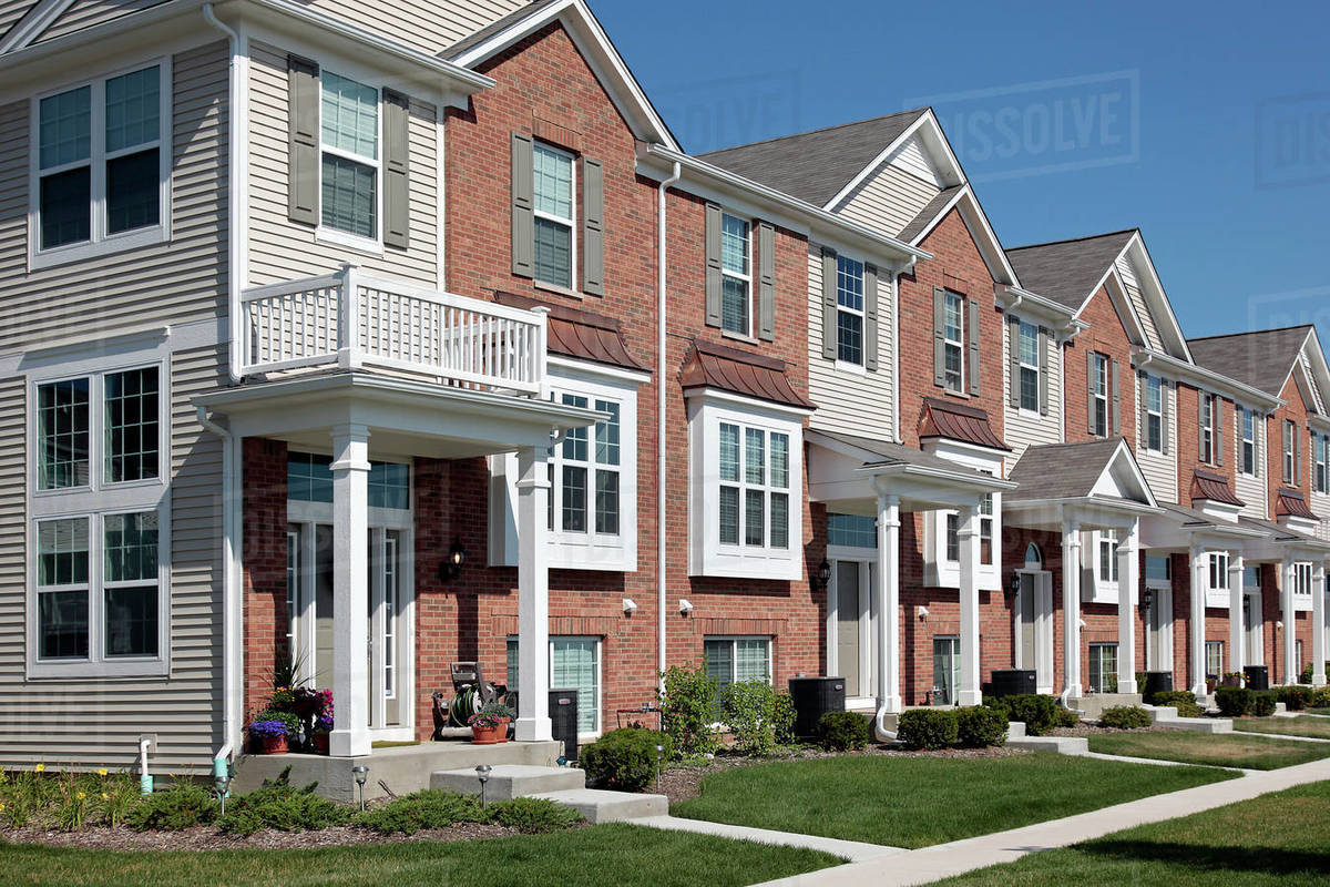 Row of brick townhouses with covered entries - Royalty-free Stock Photo ...