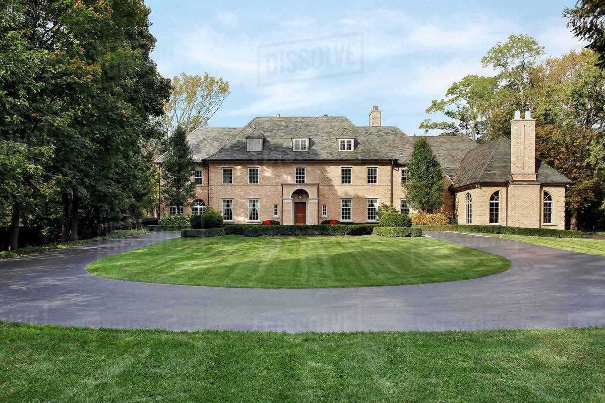 Large brick home in suburbs with front landscaping - Stock Photo - Dissolve